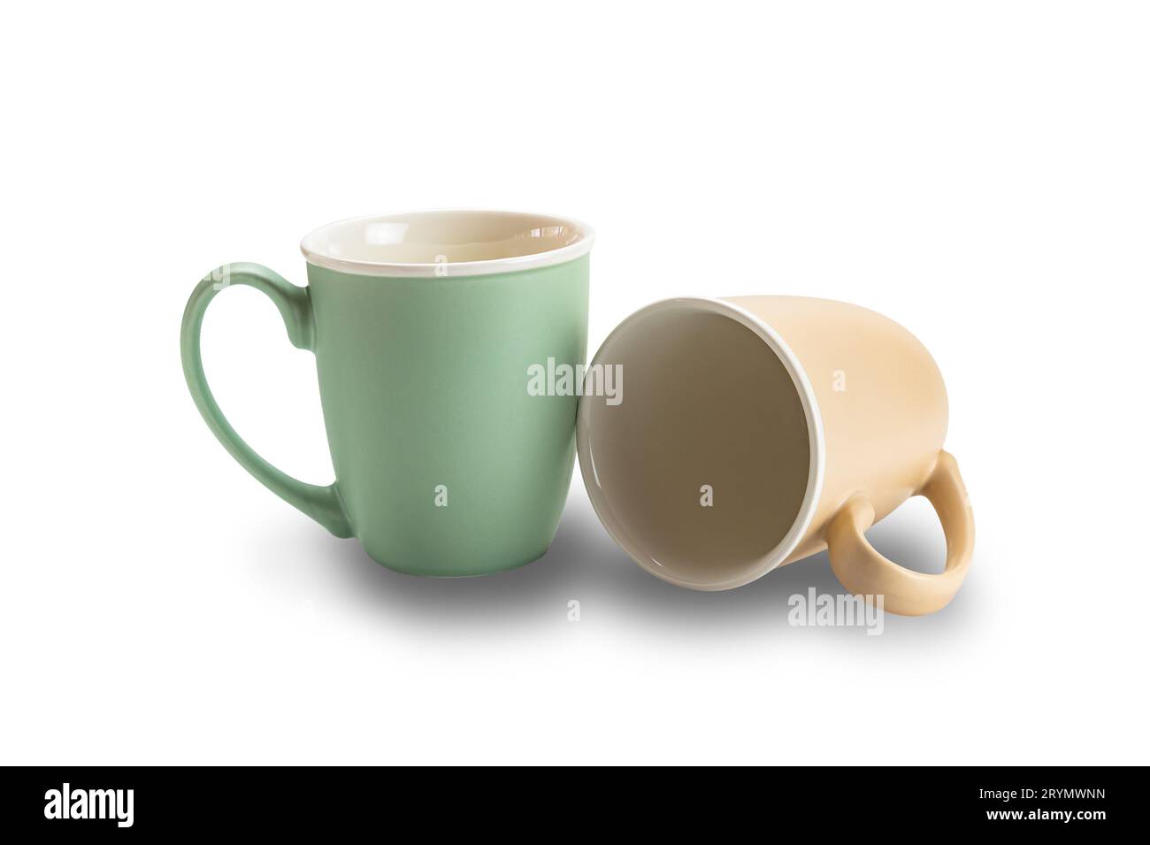 Closeup view of two empty ceramic coffee mugs brown and green isolated ...