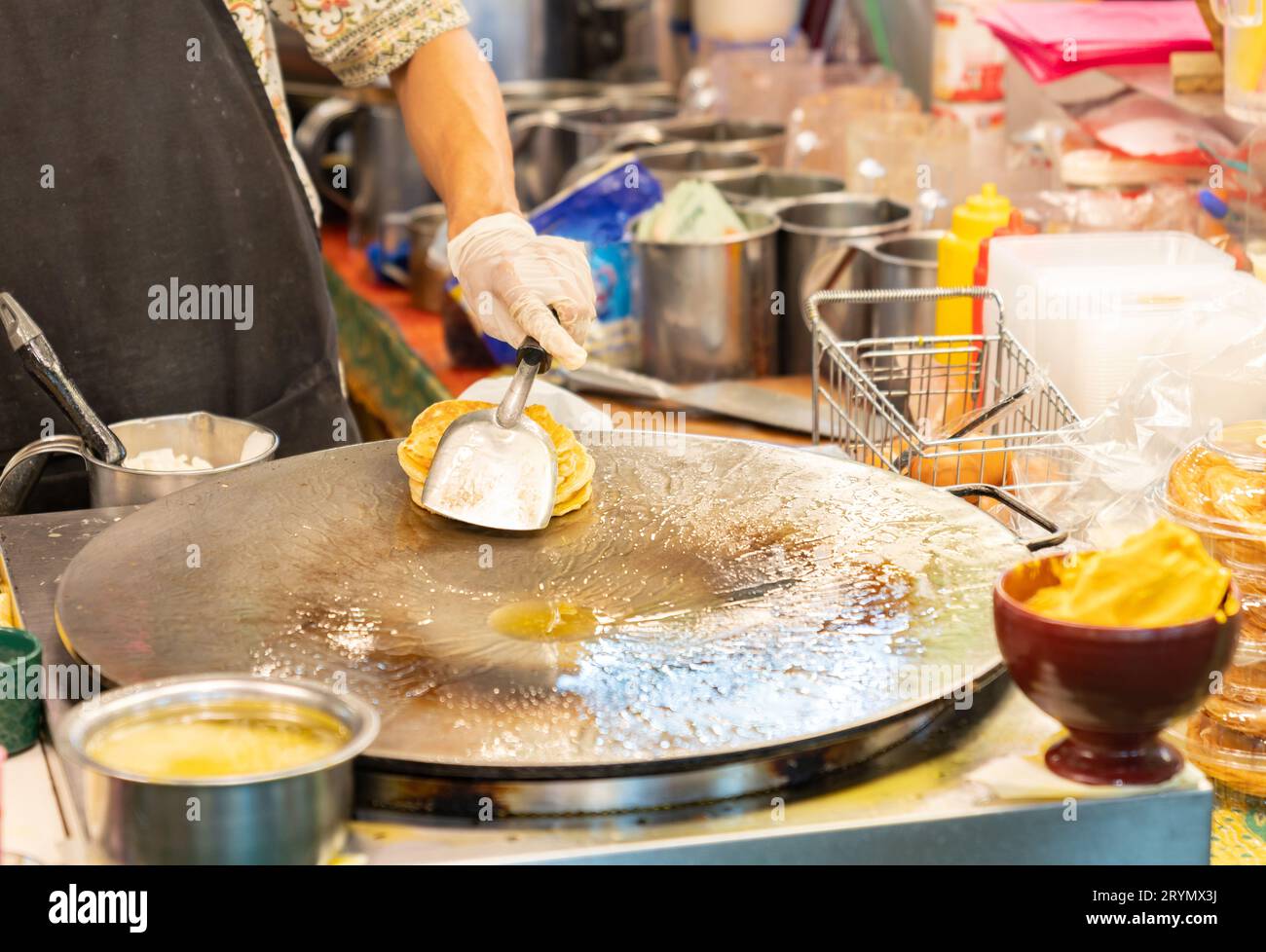 Trader fried roti on pan in street food Stock Photo - Alamy