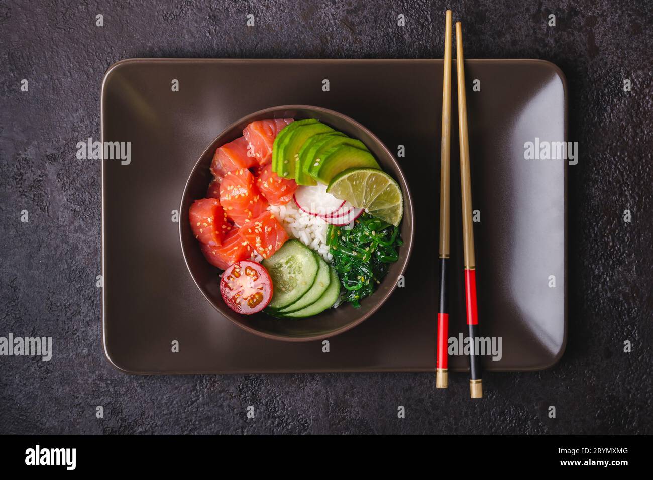 Hawaiian salmon poke salad with rice, vegetables and seaweed Stock ...