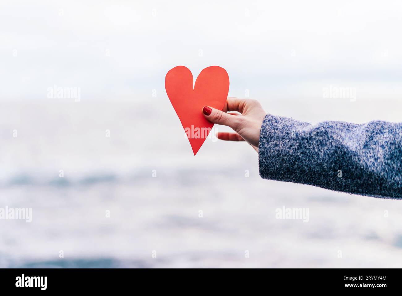 Paper heart in hand Stock Photo - Alamy