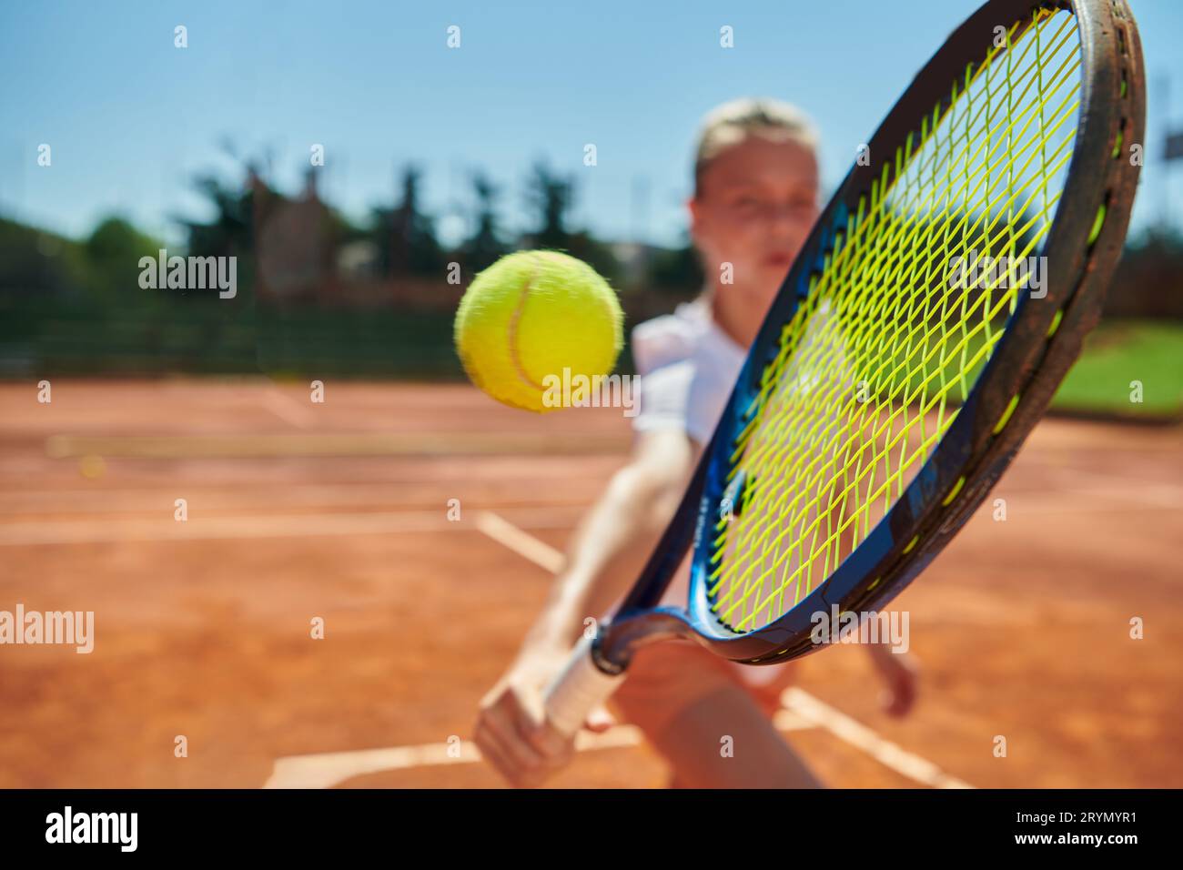 Close up photo of a young girl showing professional tennis skills in a ...