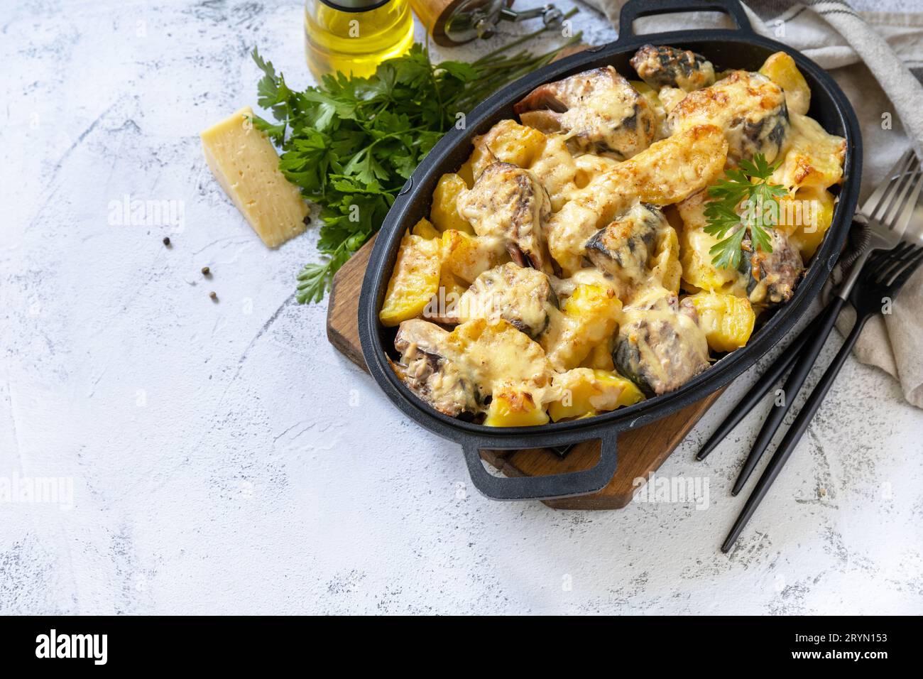Baked mackerel with potatoes and cheese on a marble tabletop. Copy ...