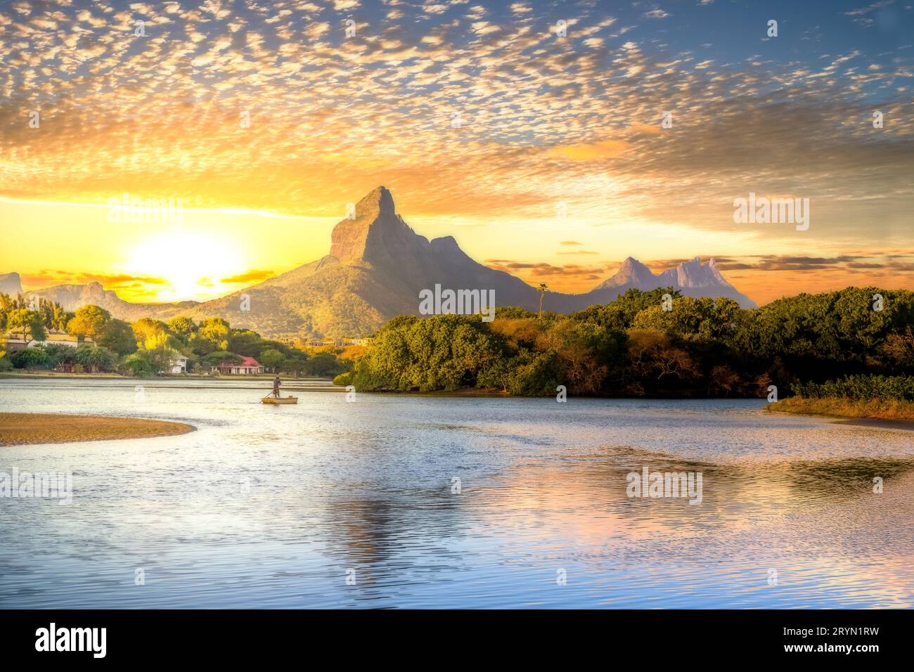 Sunset on a bay in Mauritius. with surfers in the water and great ...