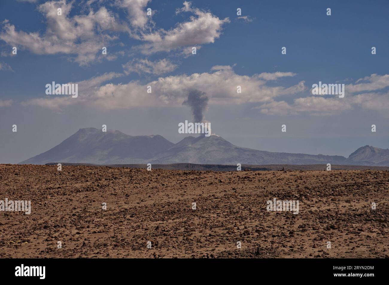 Volcano in Peru rising from the high plain and spewing out smoke Stock ...