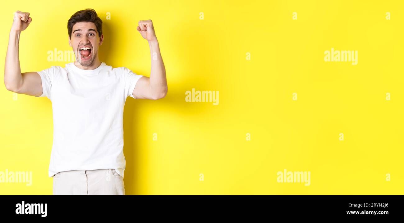 Image of excited man winning, raising hands up and celebrating ...