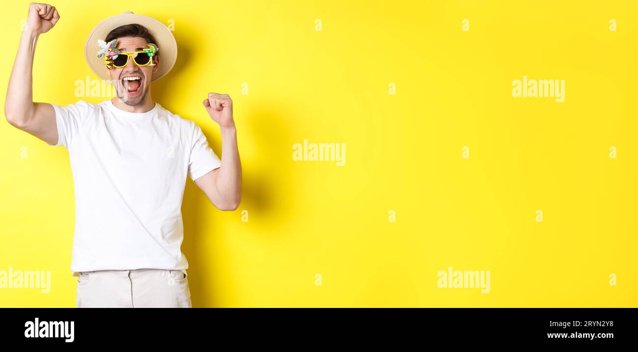 Concept of tourism and lifestyle. Happy man winning trip to resort ...