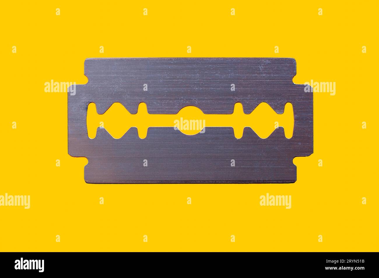 Razor blade against yellow background, symbol image, top view Stock ...