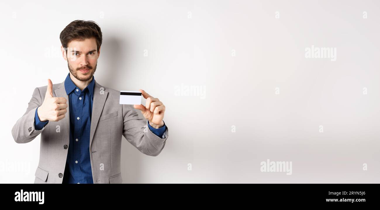 Very good bank. Businessman in suit show plastic credit card and thumb ...
