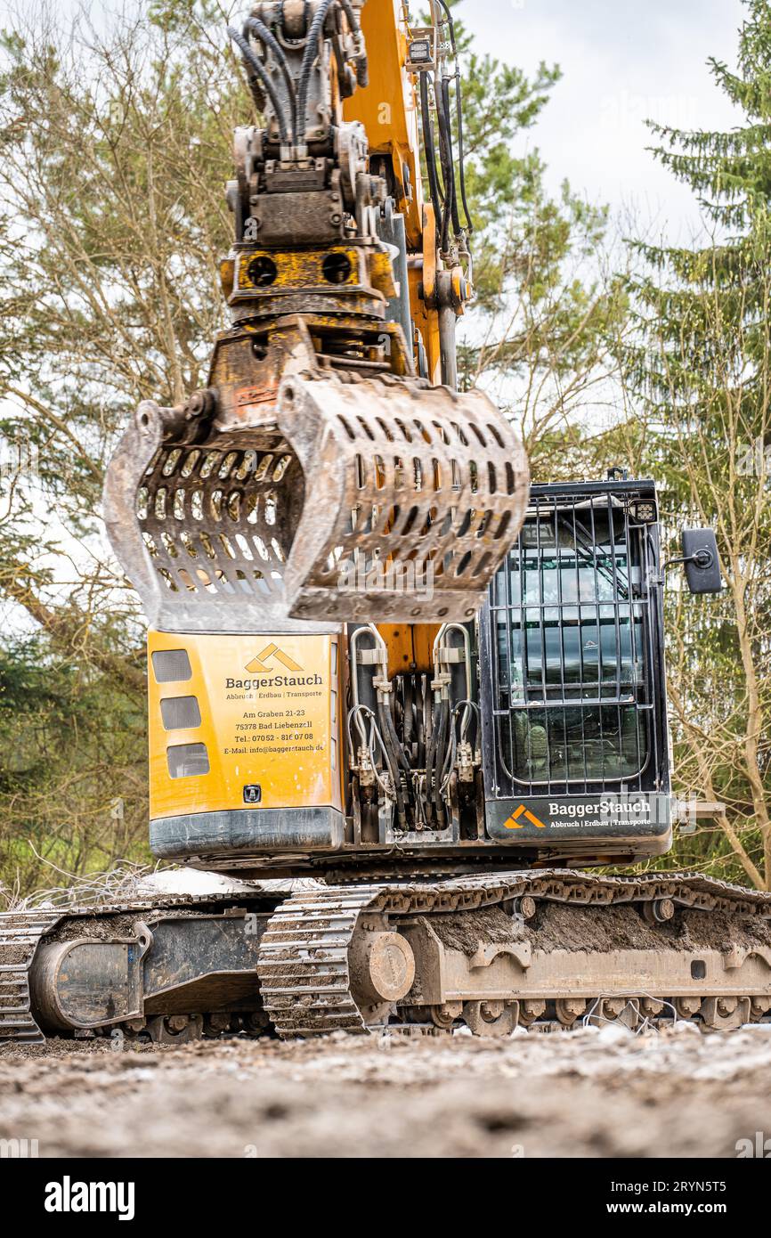 Yellow Liebherr crawler excavator recycling on demolition site Stock ...