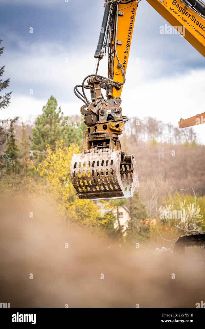 Yellow Liebherr crawler excavator recycling on demolition site Stock ...