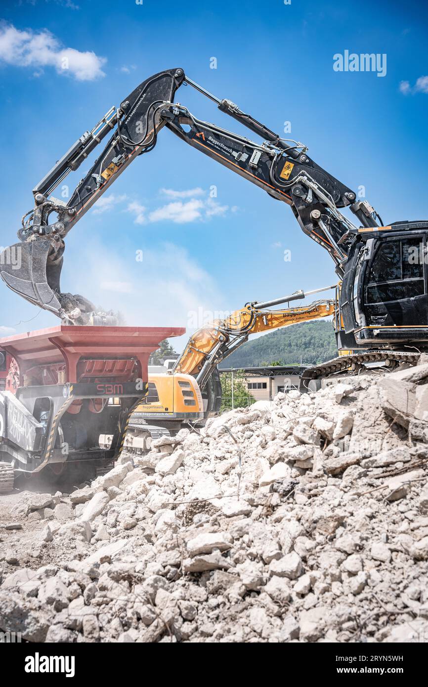 Black tracked excavator during demolition recycling on construction ...