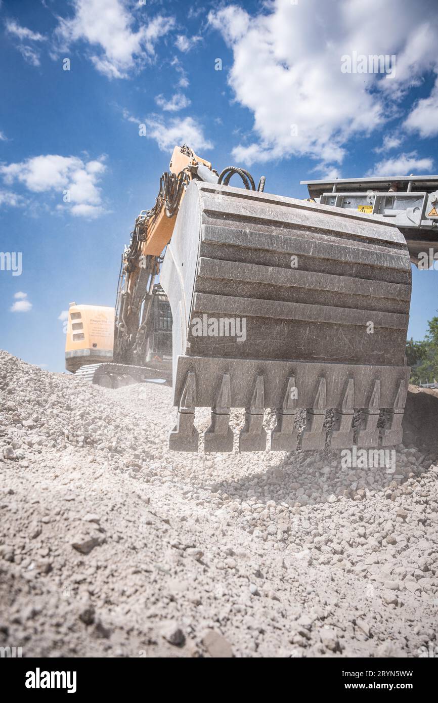Yellow tracked excavator with large bucket for demolition recycling on ...