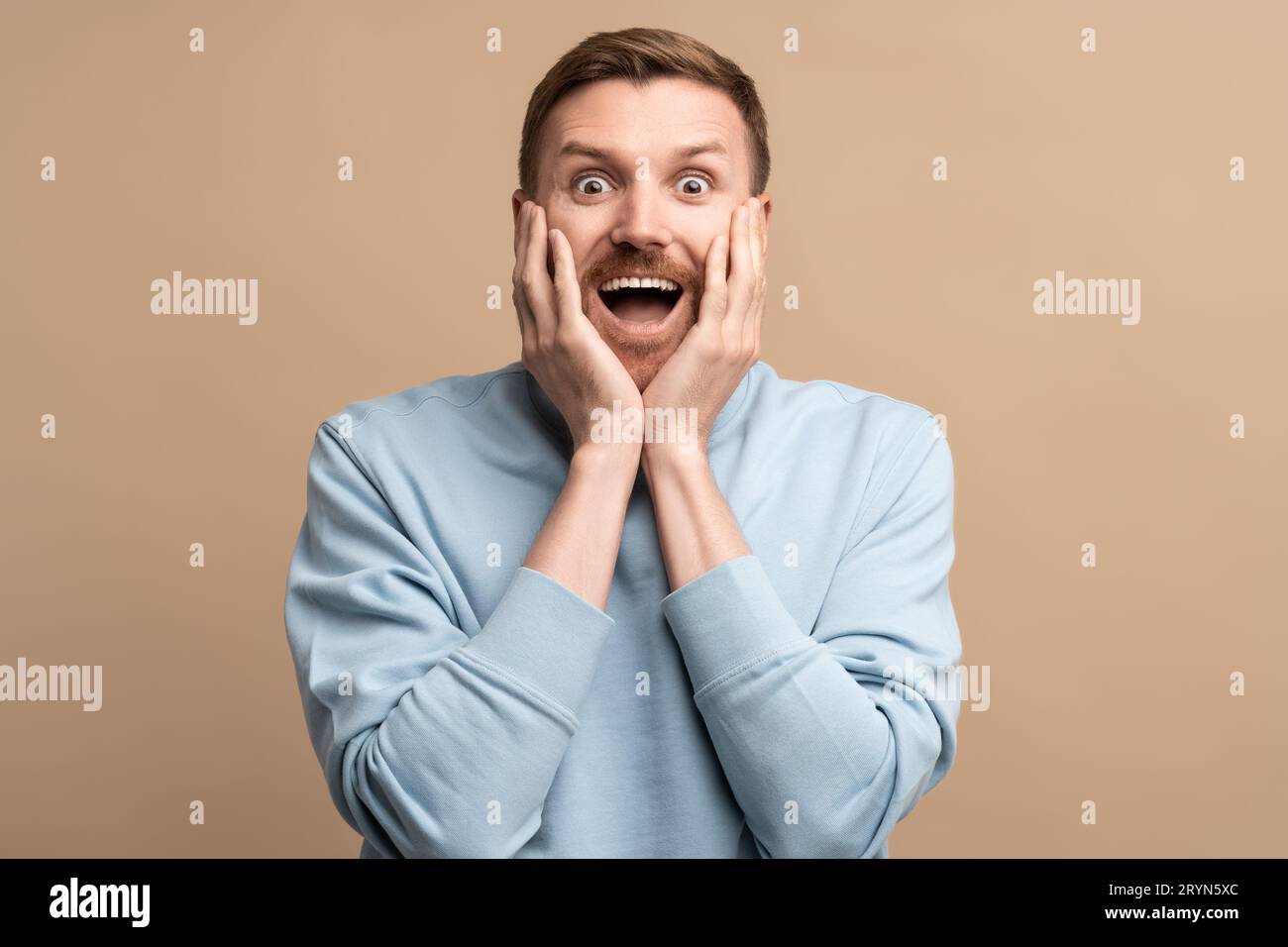 Happy surprised man looking at camera smiling with opened mouth wide ...