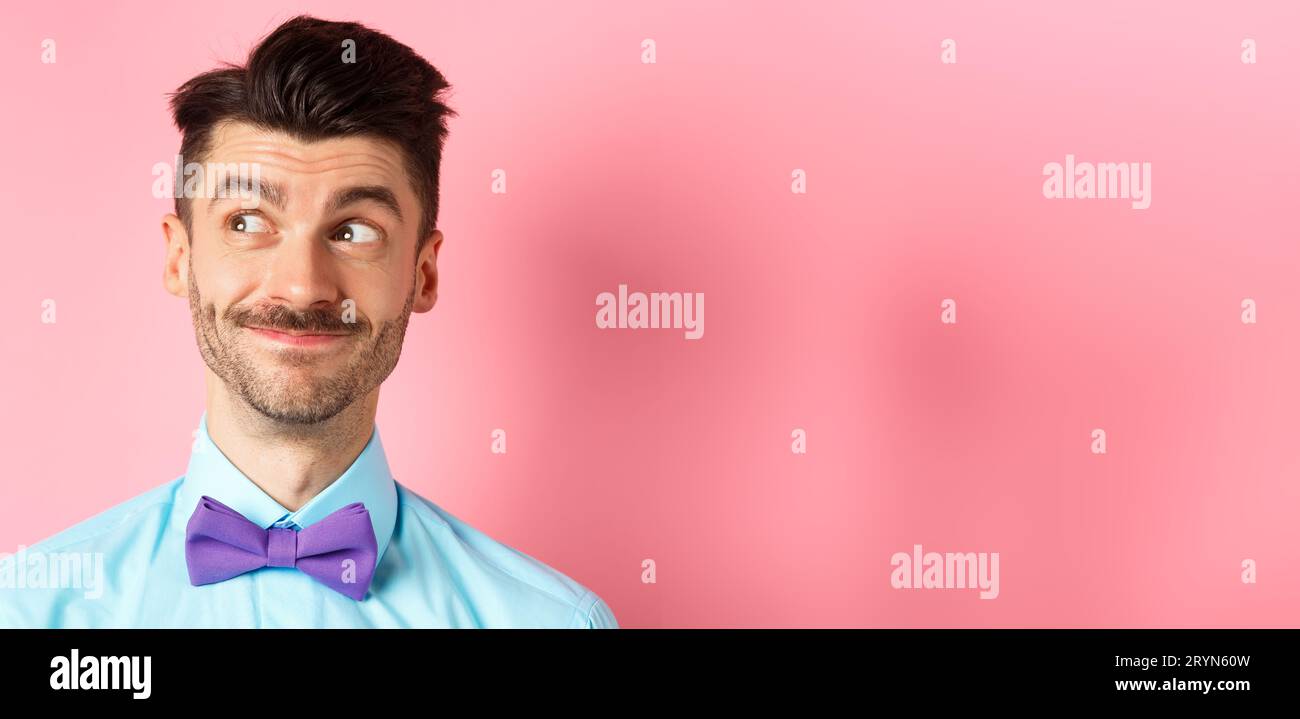 Close-up of handsome smiling guy with moustache, looking left at logo ...