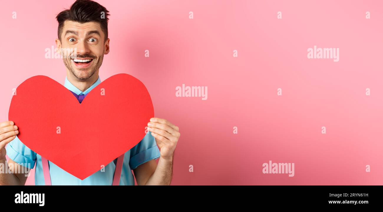 Valentines day concept. Romantic man falling in love, showing big red ...