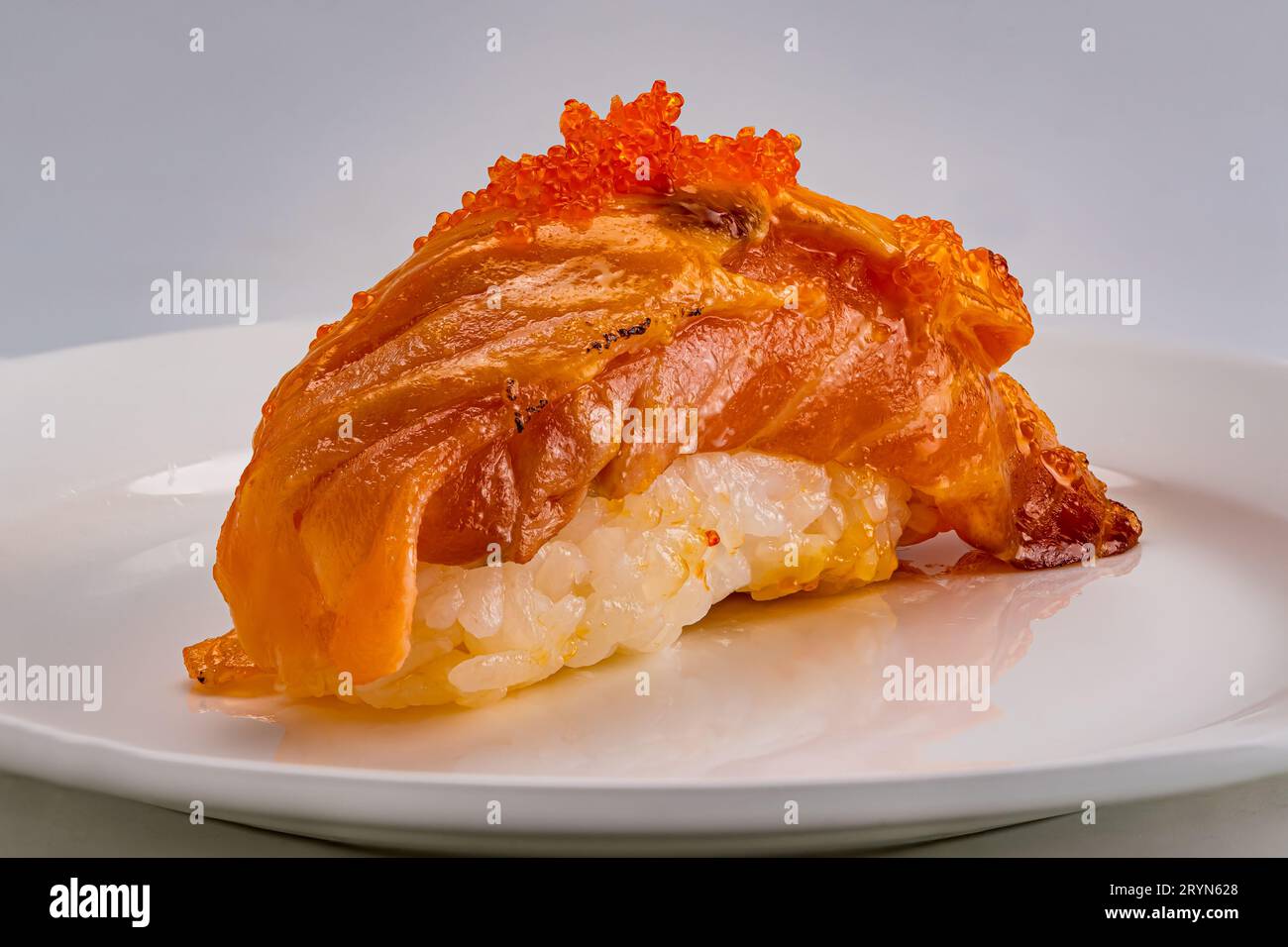 Side view of fresh homemade sushi with fish and fish eggs in white ...