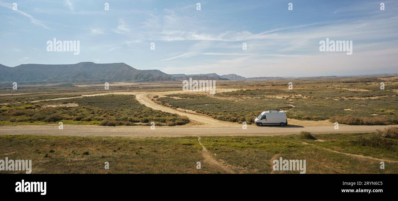 Camper van on gravel road at Bardenas Reales desert landscape, Arguedas ...