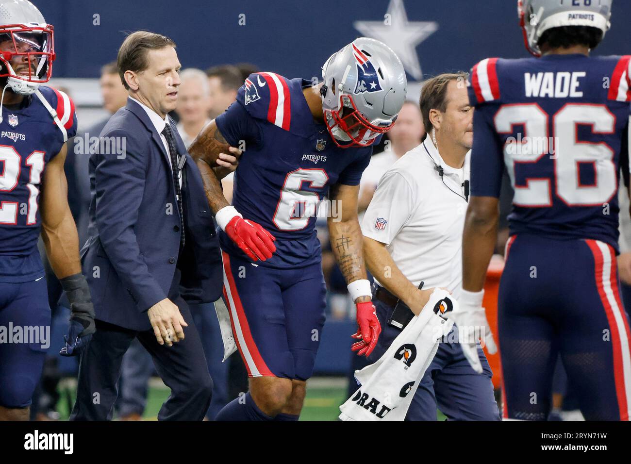 New England Patriots cornerback Christian Gonzalez (6) is escorted off ...
