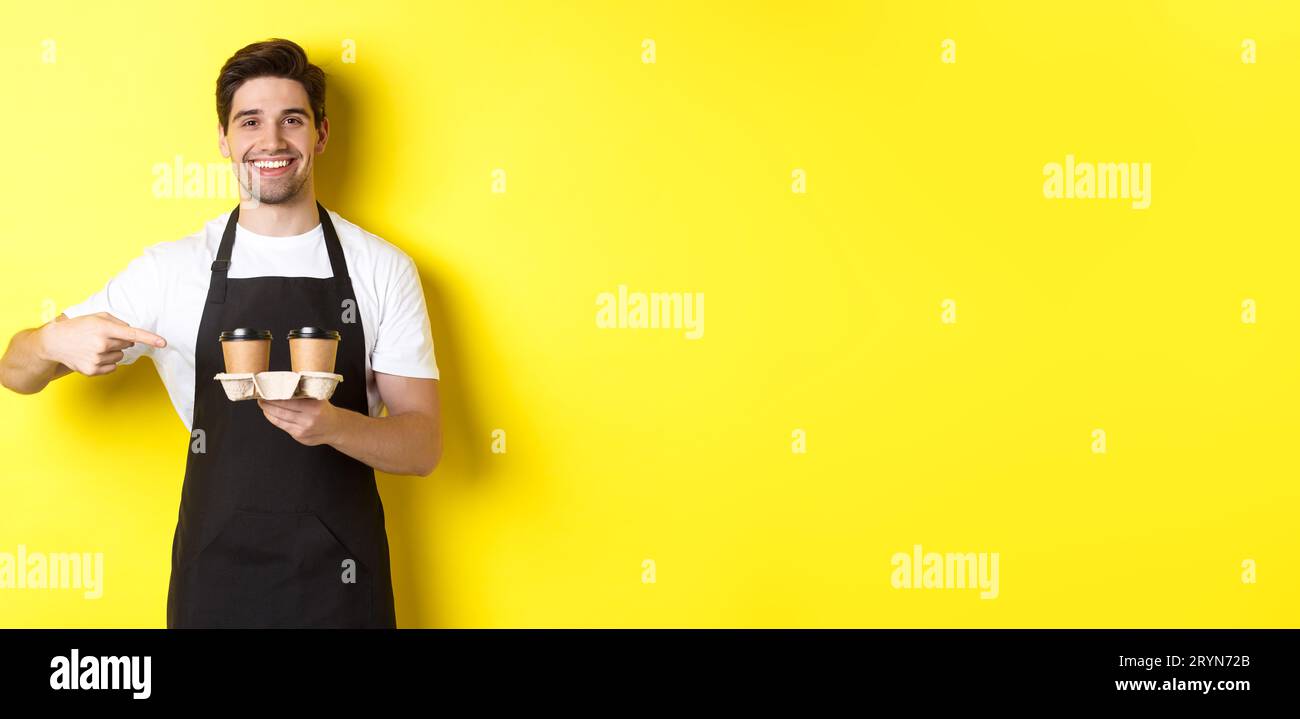Handsome barista holding pointing hi-res stock photography and images ...