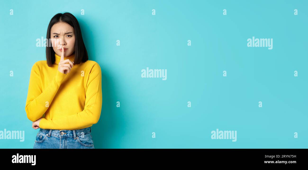 Asian woman shushing hi-res stock photography and images - Alamy