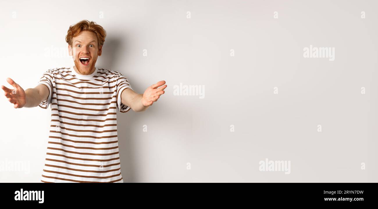 Cheerful man with red curly hair reaching hands forward, stretch out ...