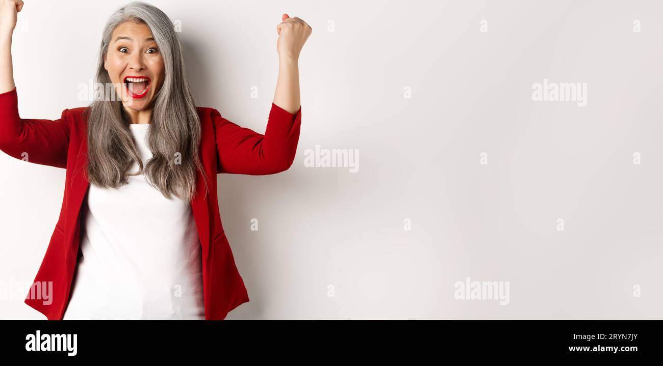 Lucky senior woman achieve success, winning prize and celebrating ...