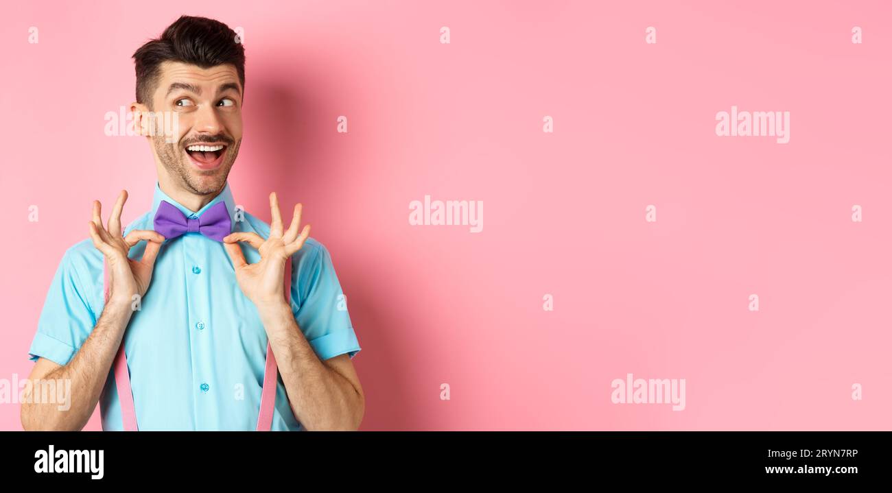 Attractive happy man fixing moustache hi-res stock photography and ...