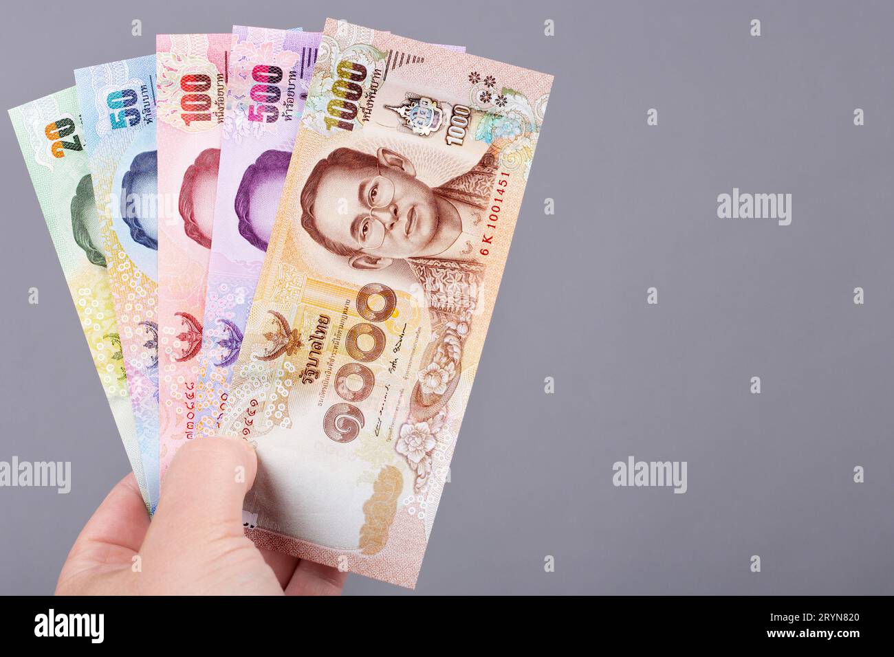 Hand on thai baht hi-res stock photography and images - Alamy