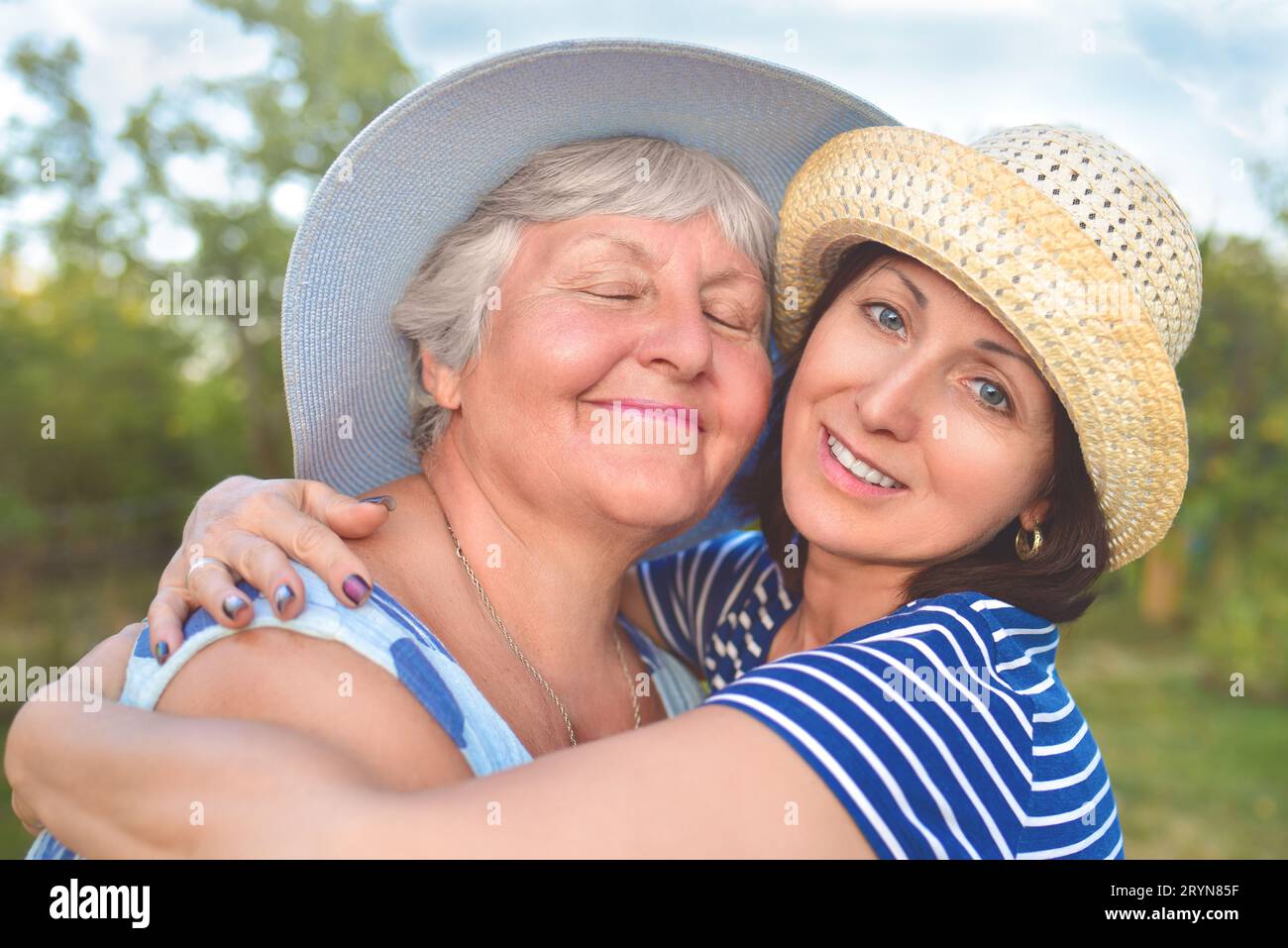 Happy daughter embracing her smiling lovely mother Stock Photo - Alamy