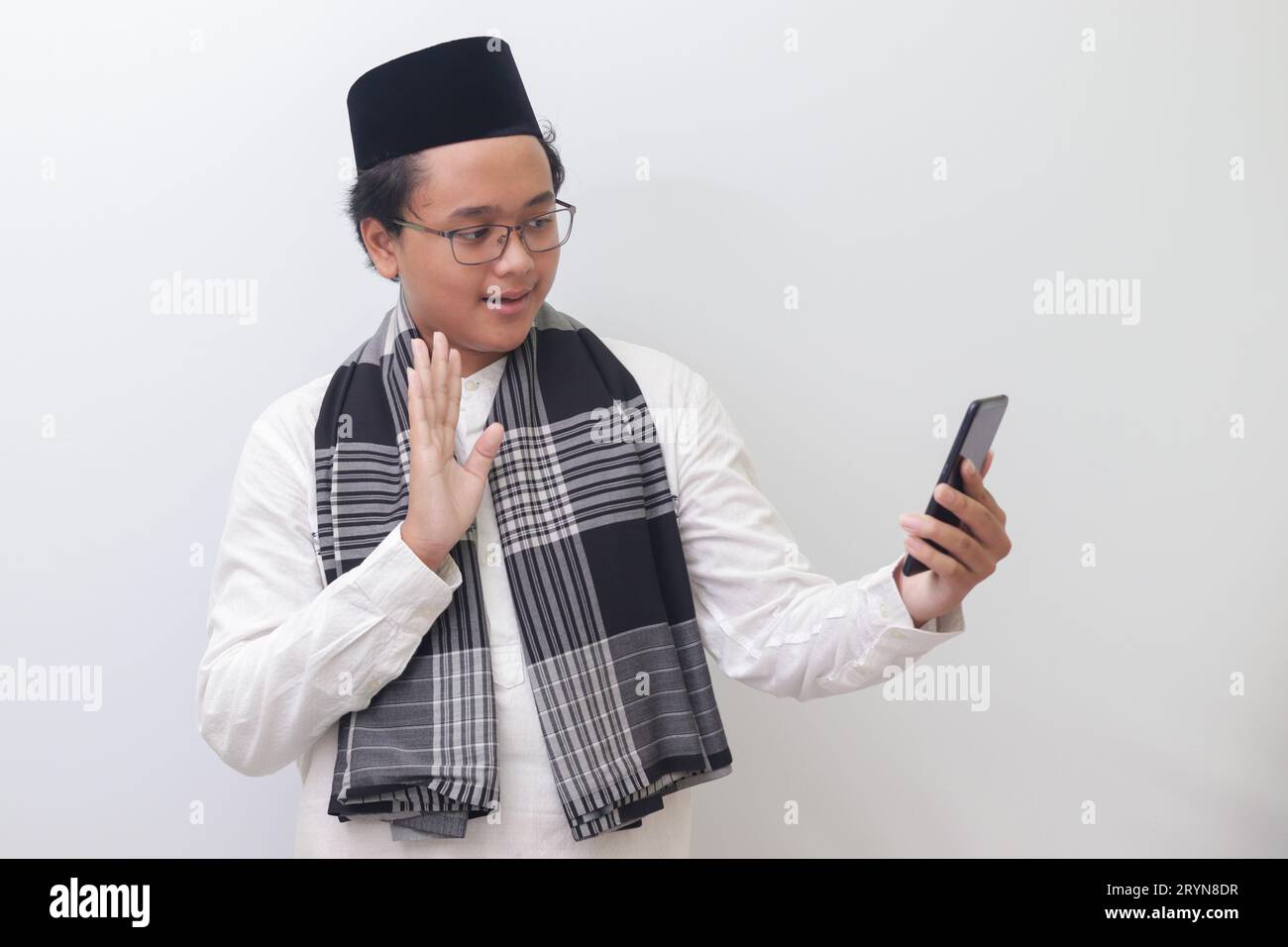 Portrait of smiling young Asian muslim man taking picture of himself or ... Portrait of smiling young Asian muslim man taking picture of himself or ...