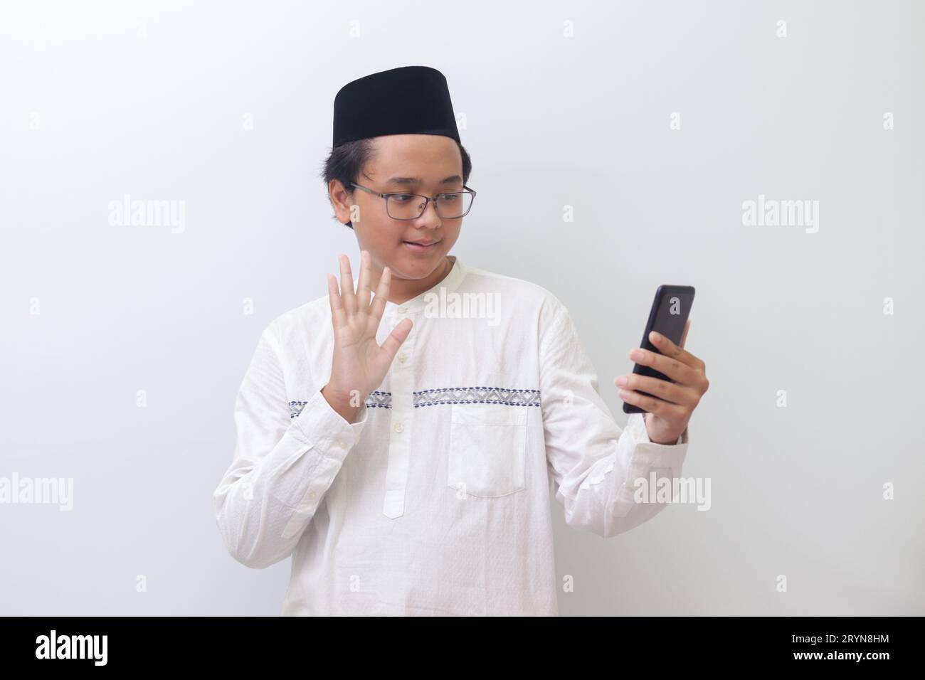Portrait of smiling young Asian muslim man taking picture of himself or ... Portrait of smiling young Asian muslim man taking picture of himself or ...