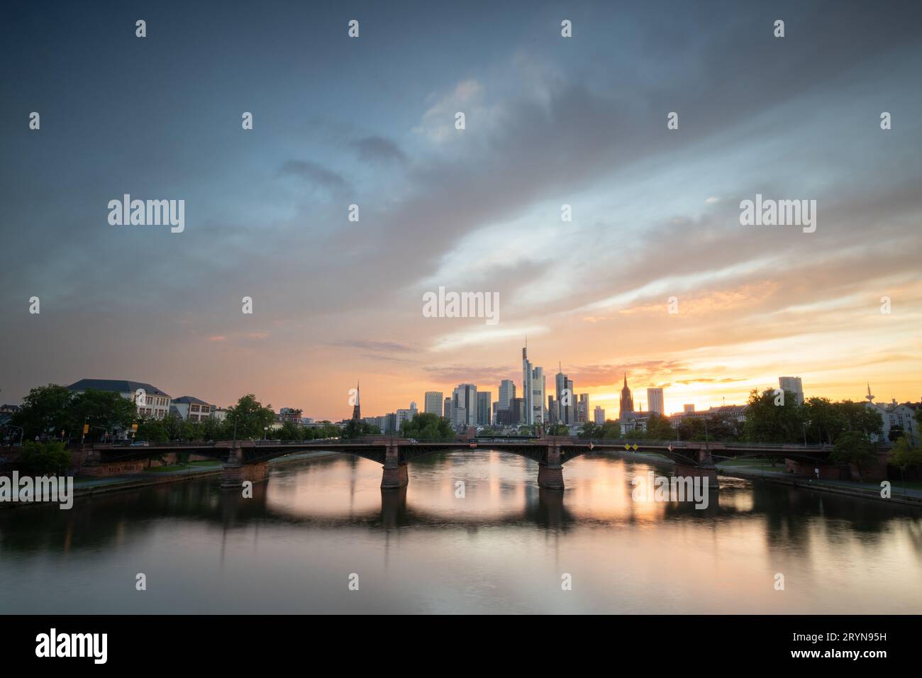 Frankfurt at sunset. Backlit shot, skyline. High-rise buildings in the ...
