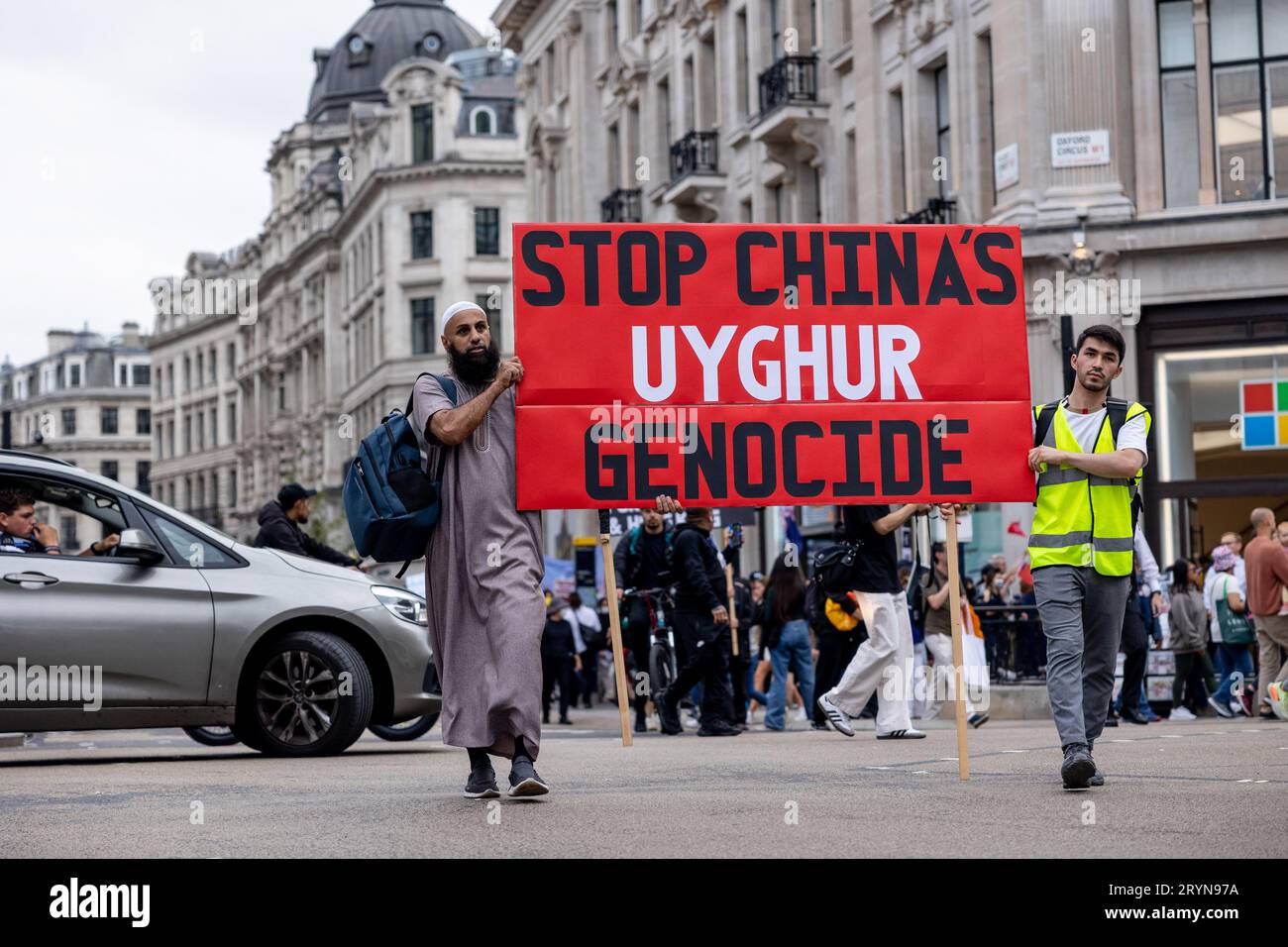 London, UK. 01st Oct, 2023. A Uyghur is seen holding a huge placard ...