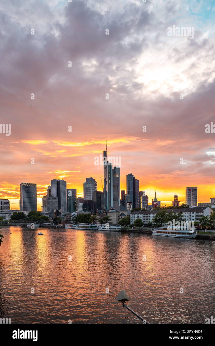 Frankfurt at sunset. Backlit shot, skyline. High-rise buildings in the ...