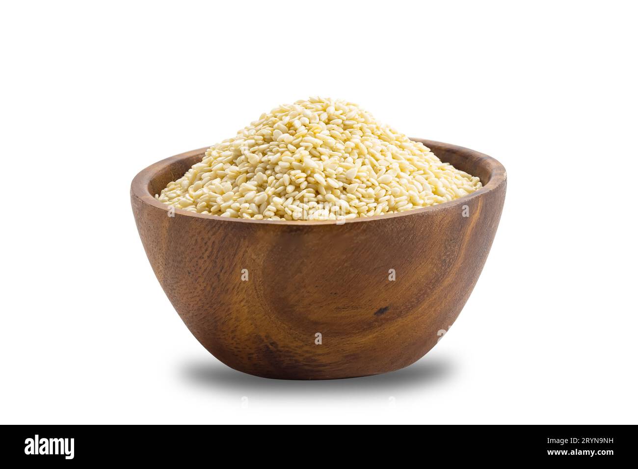Side view of white dry sesame in wooden bowl isolated on white ...