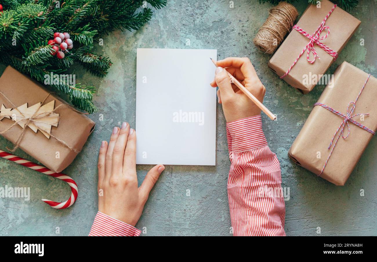 Writing goals for the next year. Women's hands write wishes on a white ...
