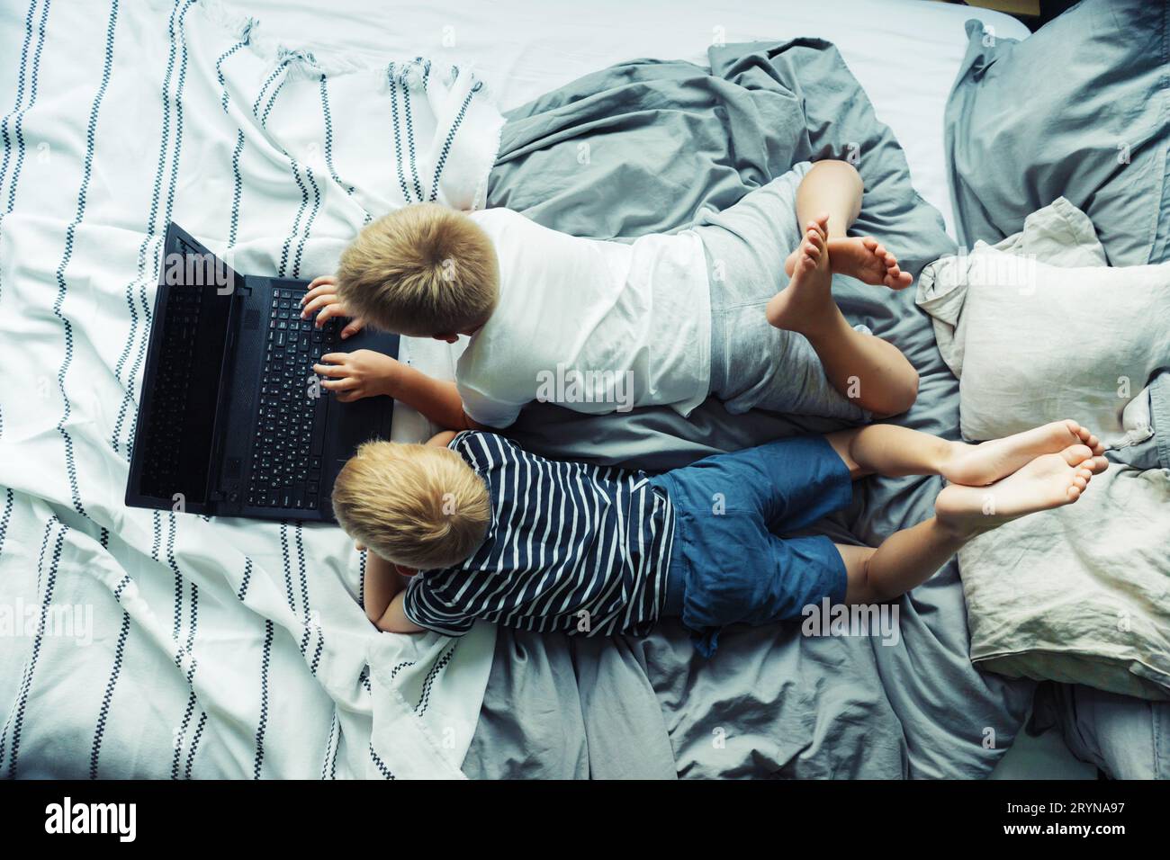 Two boys using laptop home hi-res stock photography and images - Alamy