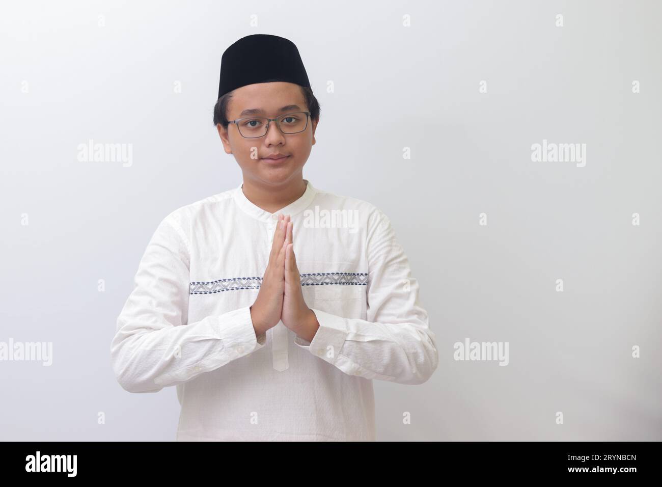 Portrait of young Asian muslim man showing apologize and welcome hand ...