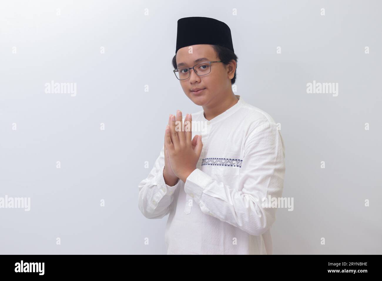 Portrait of young Asian muslim man showing apologize and welcome hand ...