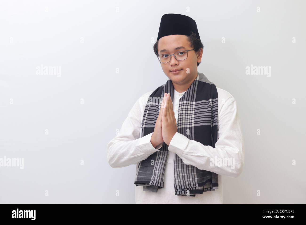 Portrait of young Asian muslim man showing apologize and welcome hand ...