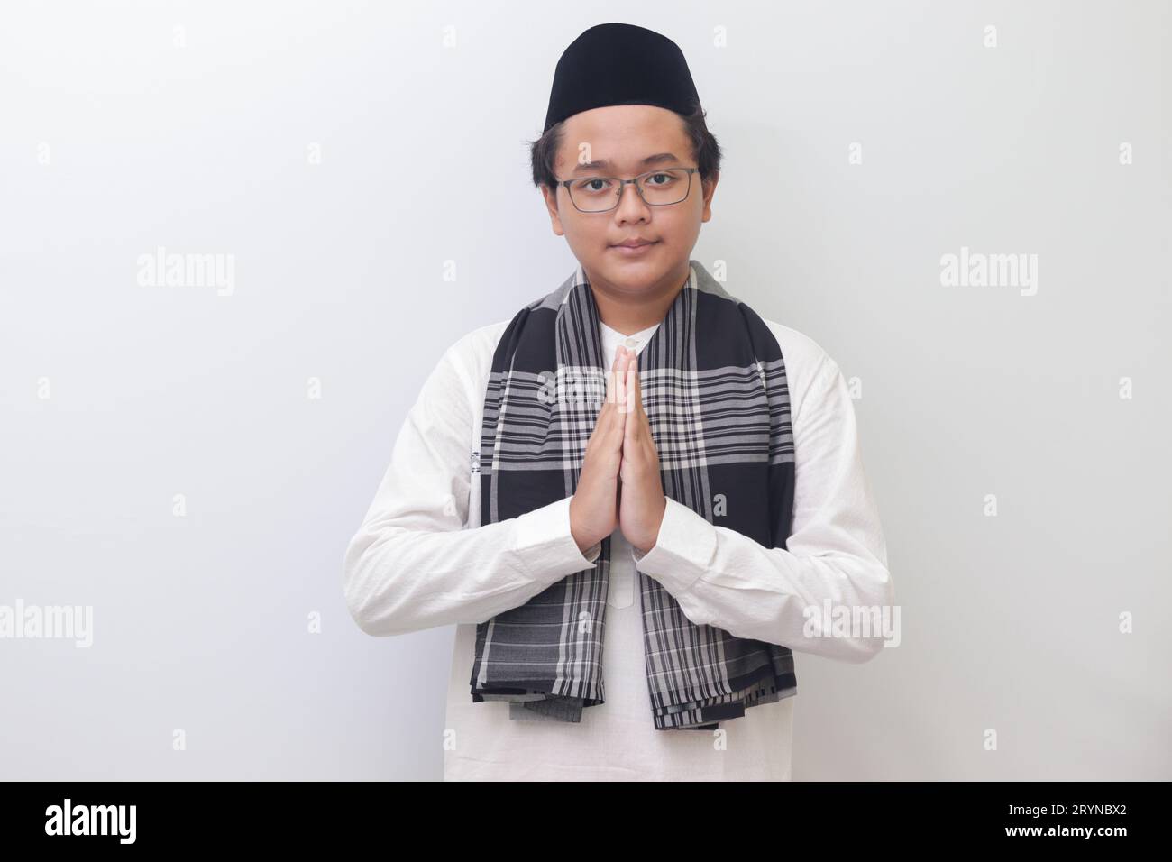 Portrait of young Asian muslim man showing apologize and welcome hand ...