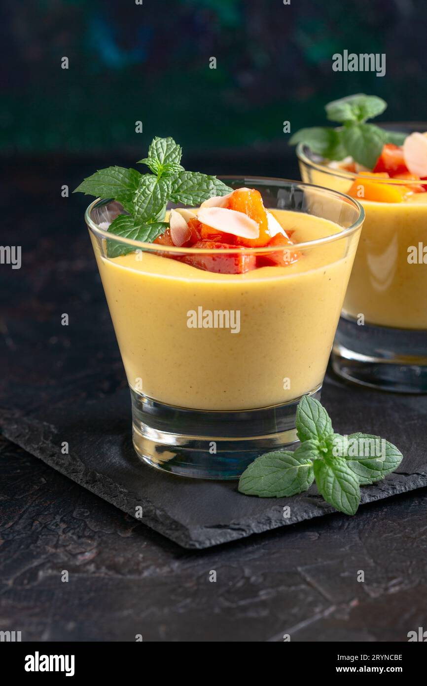 Creamy peach dessert with peach pieces and mint Stock Photo - Alamy