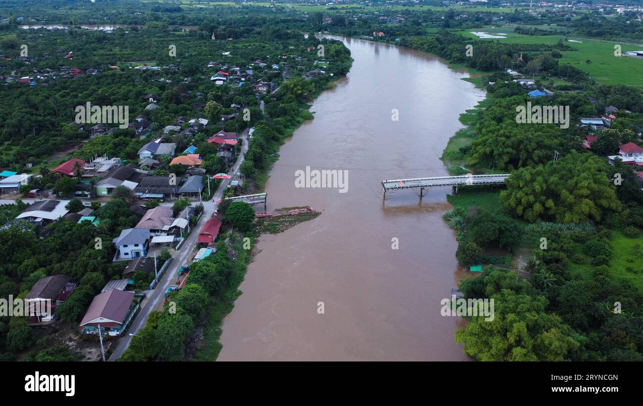 Aerial view of a damaged road bridge over a river after floodwaters ...