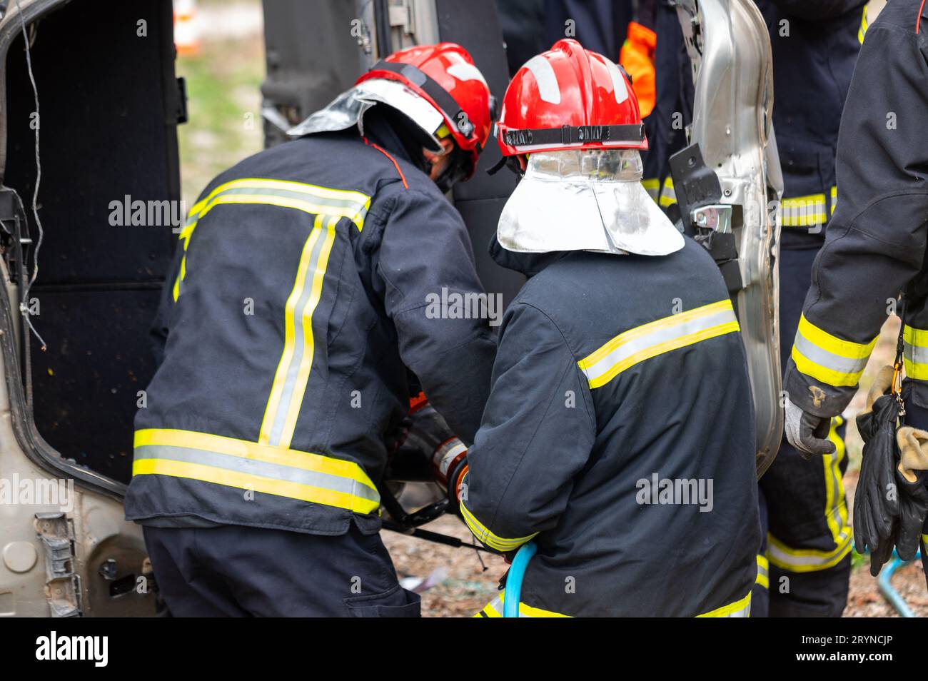 Firefighters using hydraulic tools during a rescue operation training ...