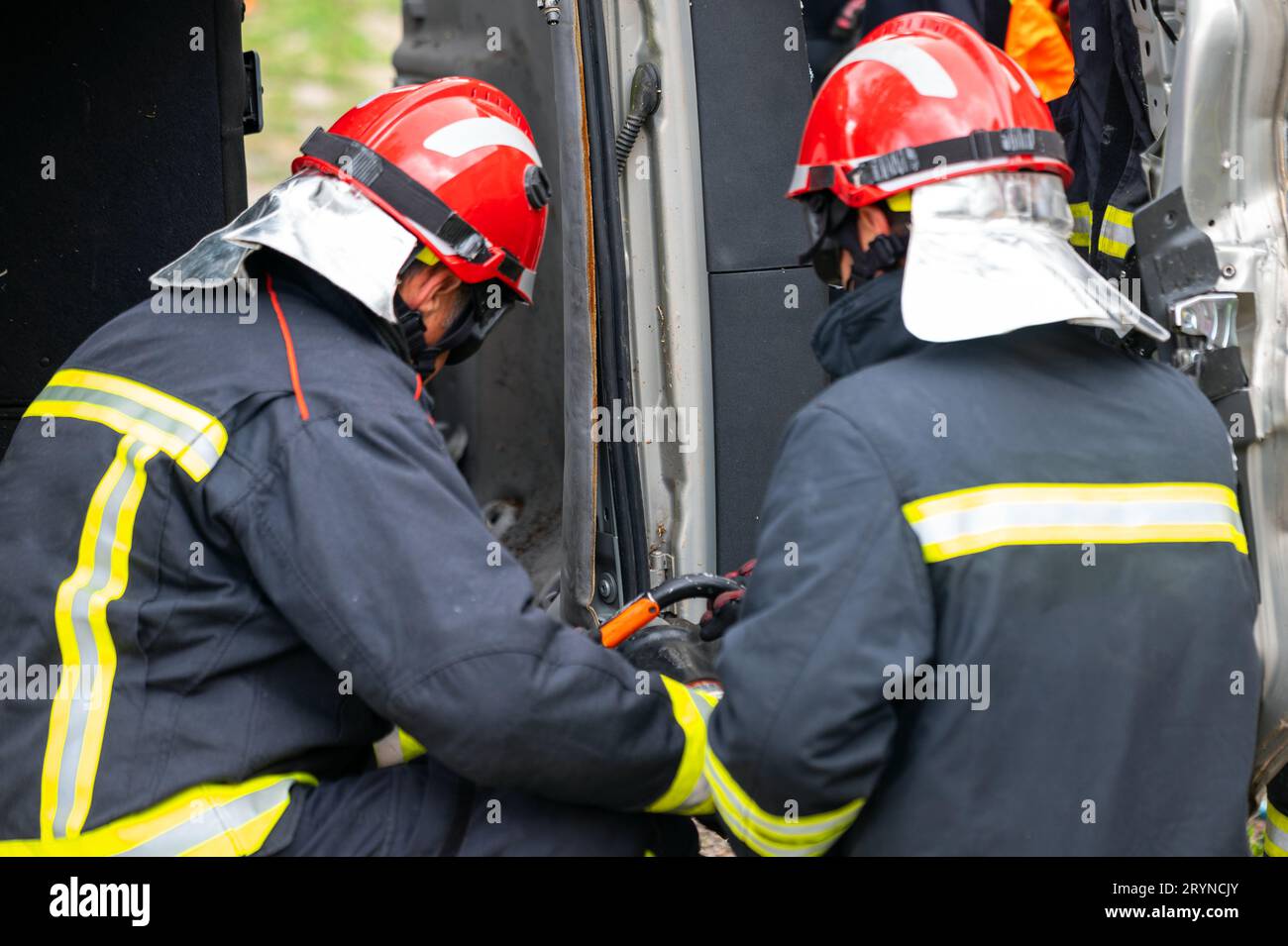 Firefighters using hydraulic tools during a rescue operation training ...