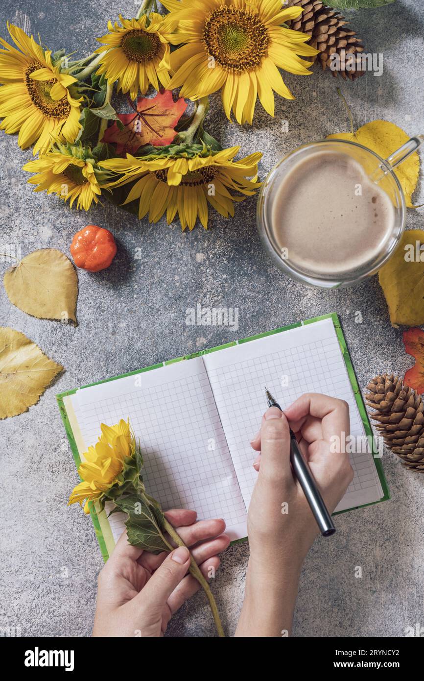 Good Morning. To do list concept. A bouquet of large sunflowers, coffee ...