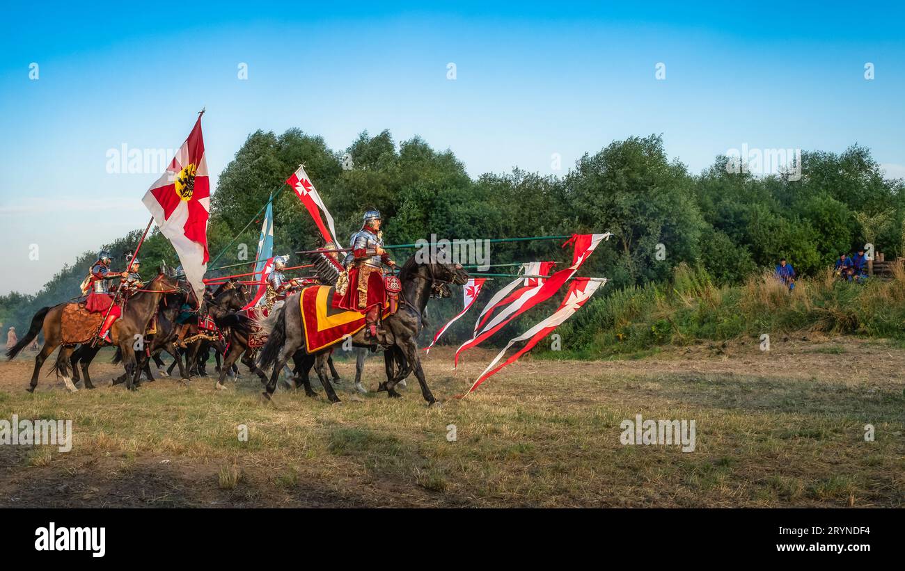 Hussars holding long lances and charging on enemies, historical ...
