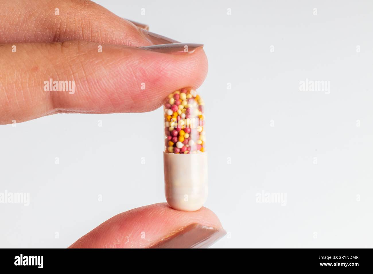 White drug capsule hand hi-res stock photography and images - Alamy