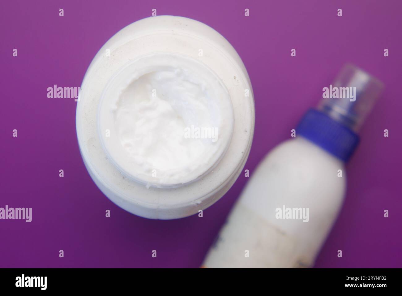 Bottle of Glue Spilling on black background Stock Photo - Alamy