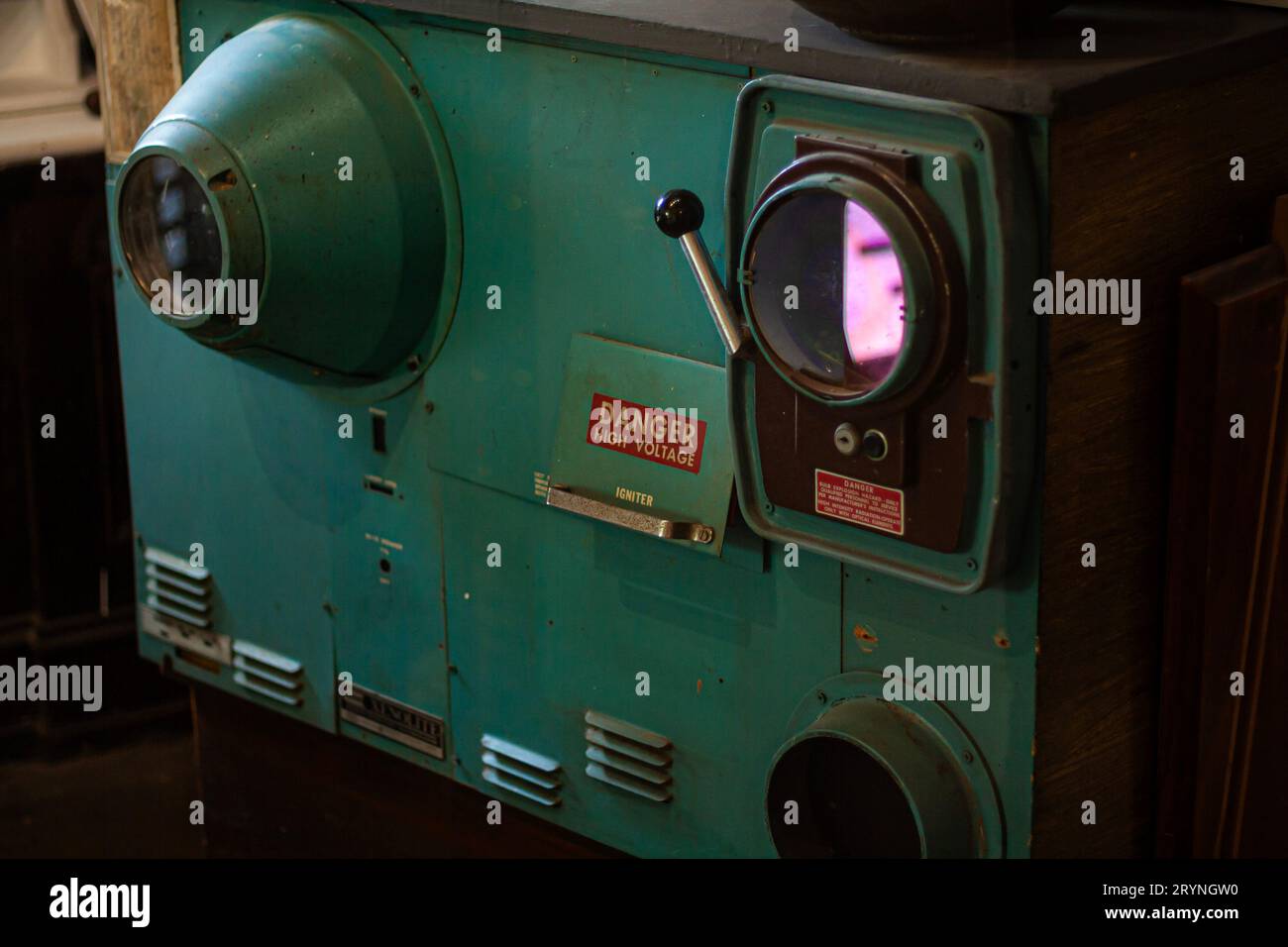 A retro vintage machine with lenses and a lever, label "Danger: High ...